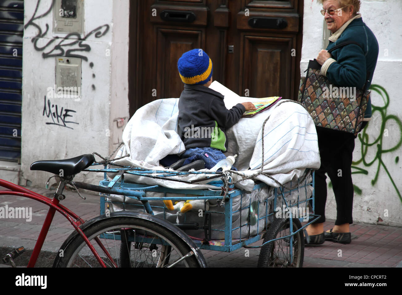 A poor Child begging to a old woman. Photo taken in San Telmo, Buenos ...