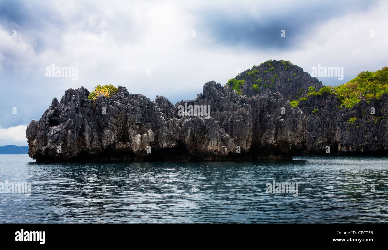 Limestone formations rise gracefully from the blue ocean waters of El ...