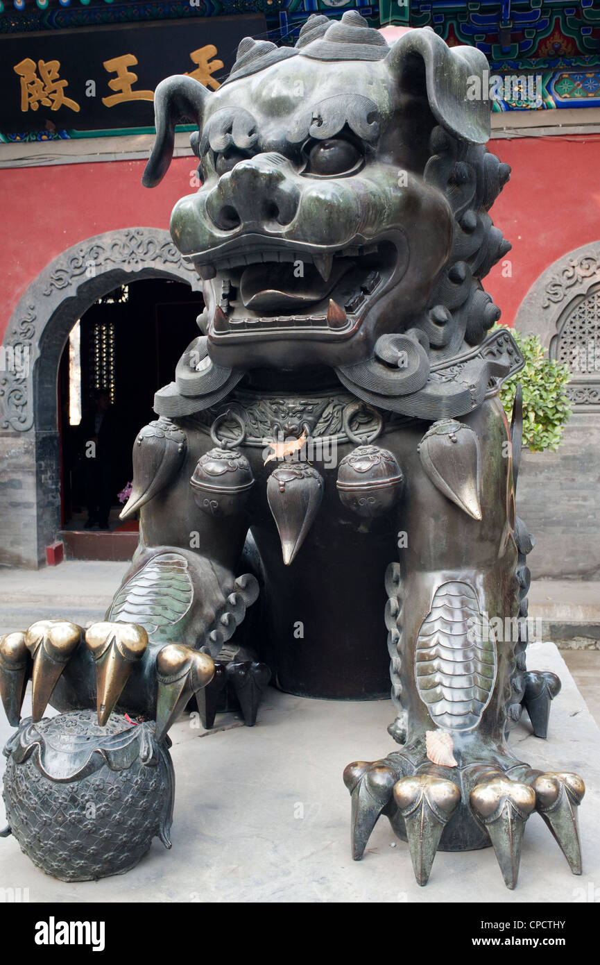 A copper lion in front of the ancient temple Stock Photo - Alamy