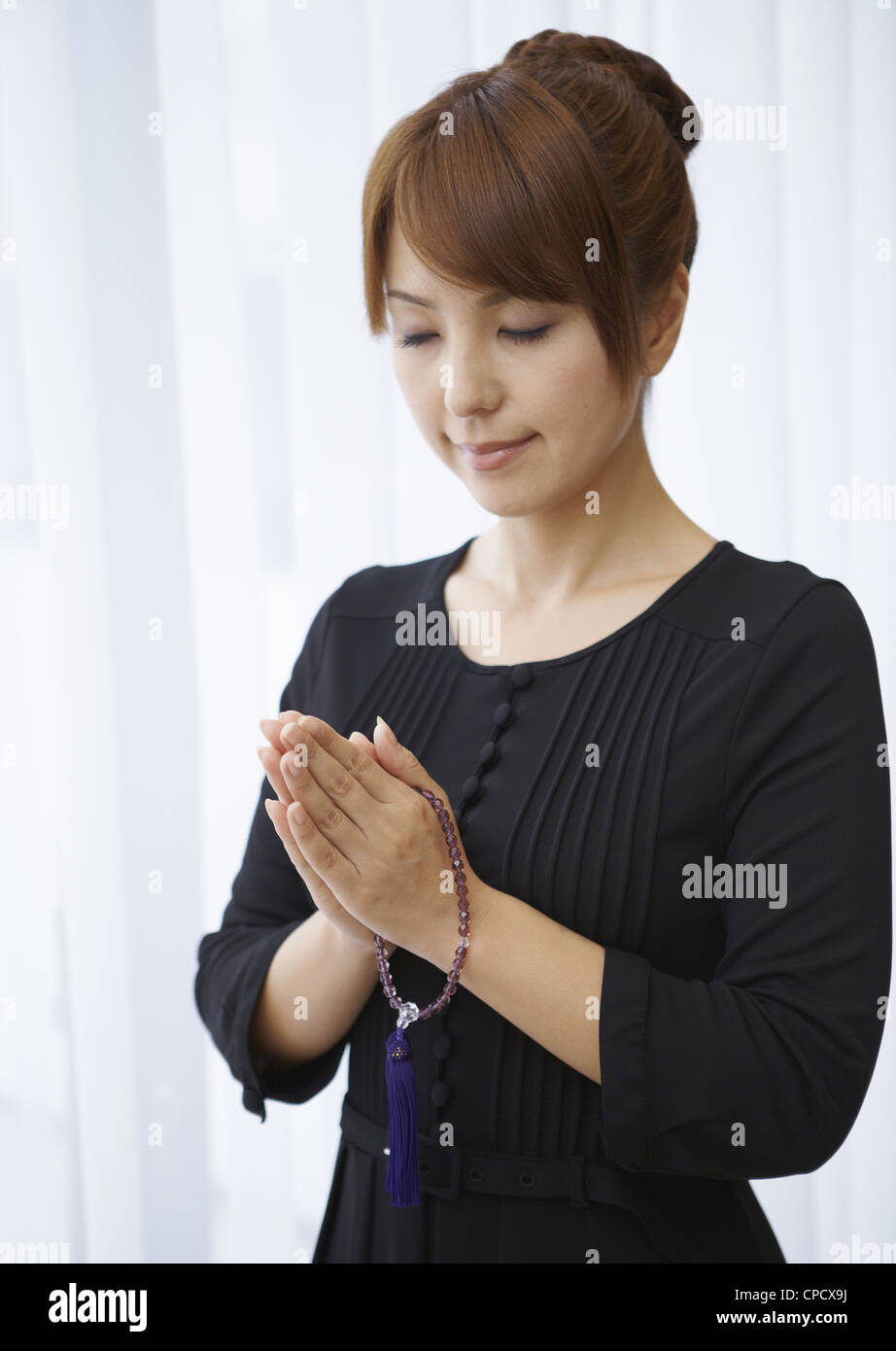 Woman with hands together in prayer (Mourning image Stock Photo - Alamy