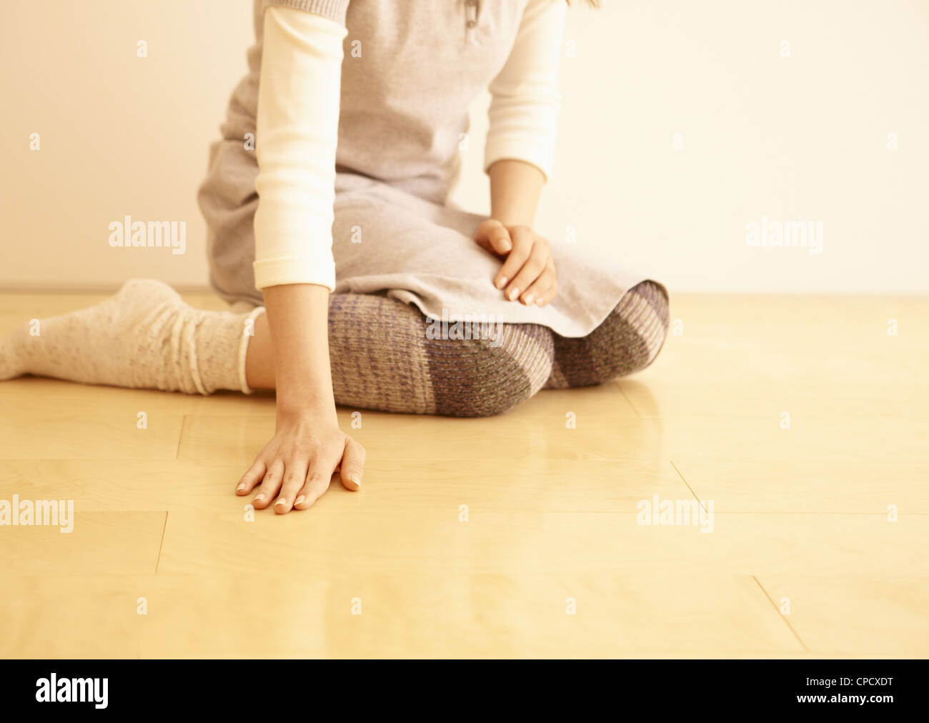 Young woman touching floor (Floor heating image Stock Photo - Alamy