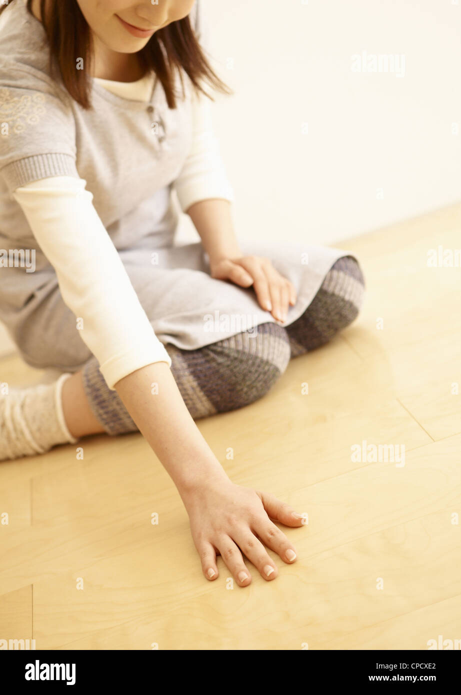 Young woman touching floor (Floor heating image Stock Photo - Alamy