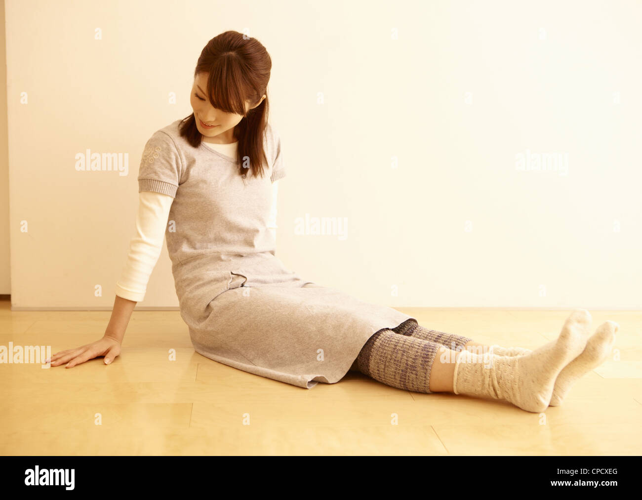 Young woman touching floor (Floor heating image Stock Photo - Alamy