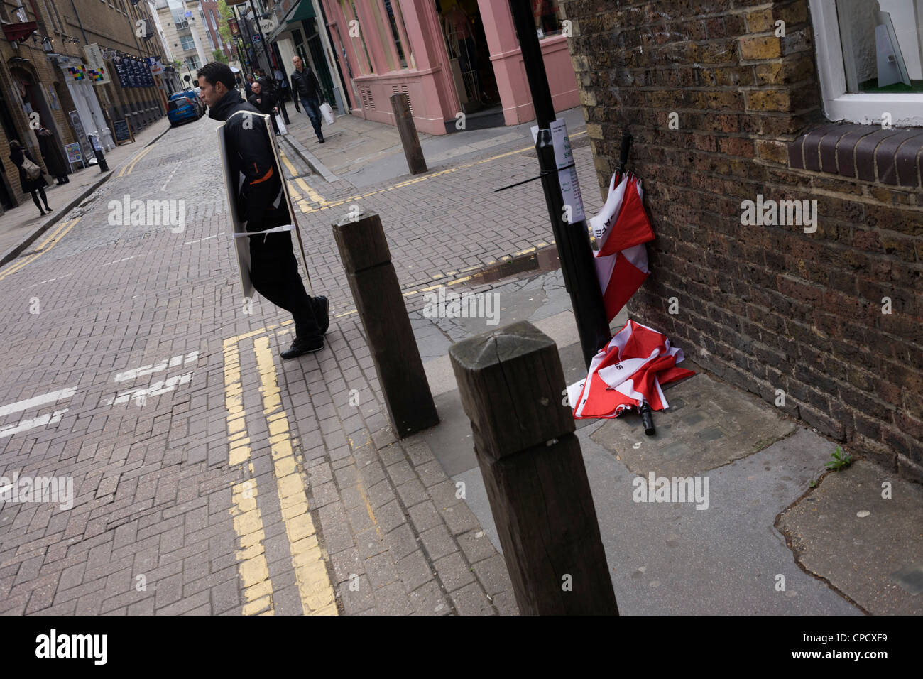 A Sandwich board man seemingly sandwiched by his own sign in a central ...