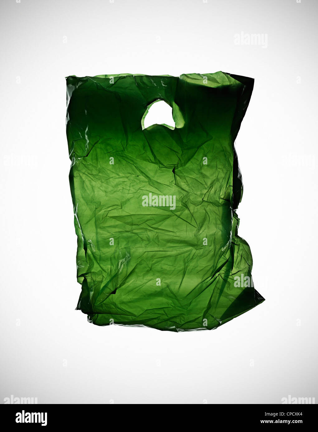 Crumpled green plastic bag on table Stock Photo - Alamy