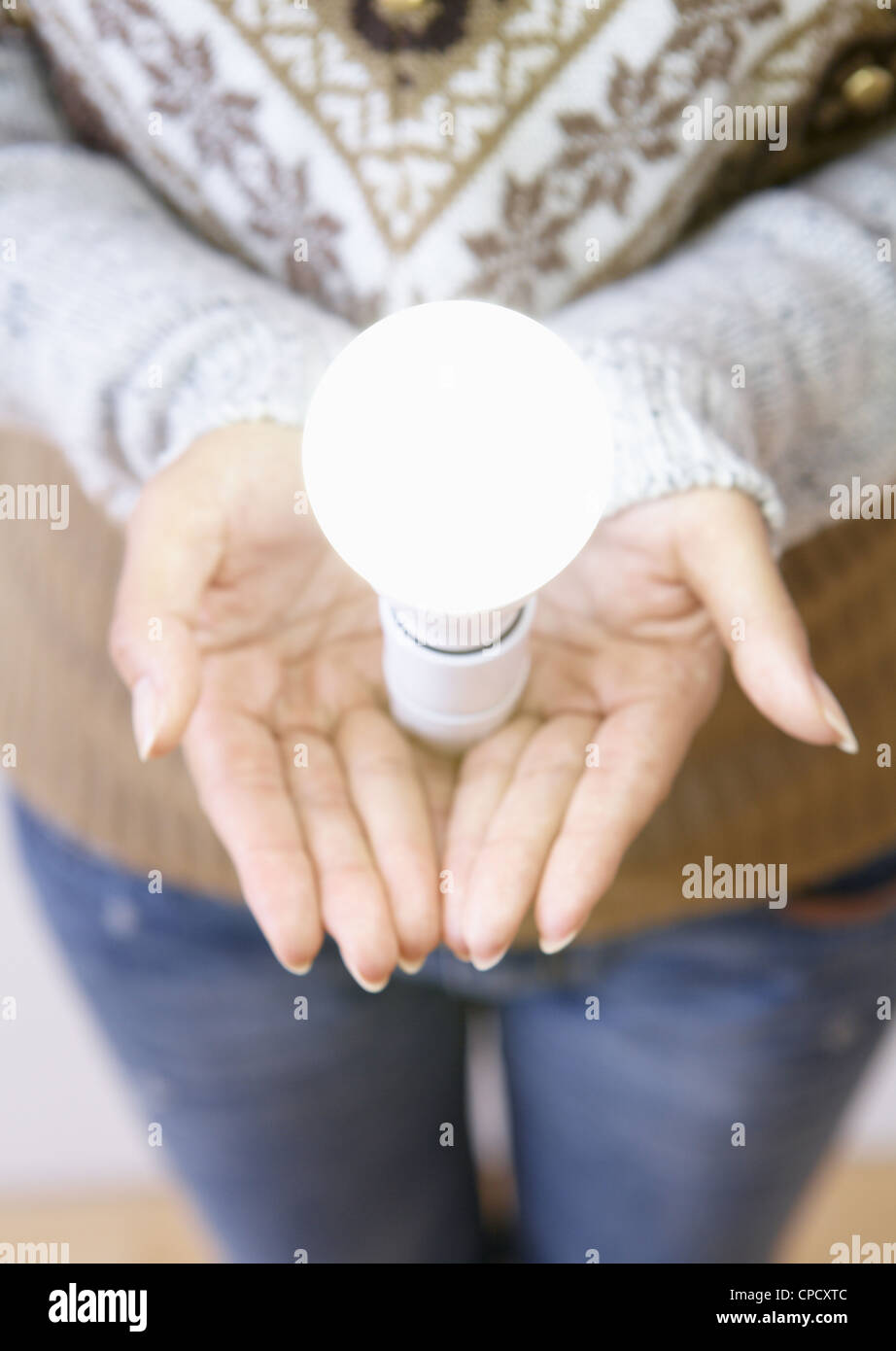 Hands holding LED bulb Stock Photo - Alamy