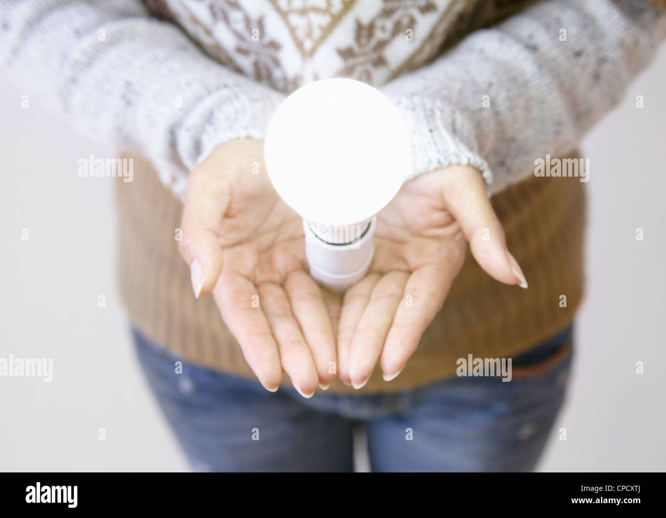 Hands holding LED bulb Stock Photo - Alamy