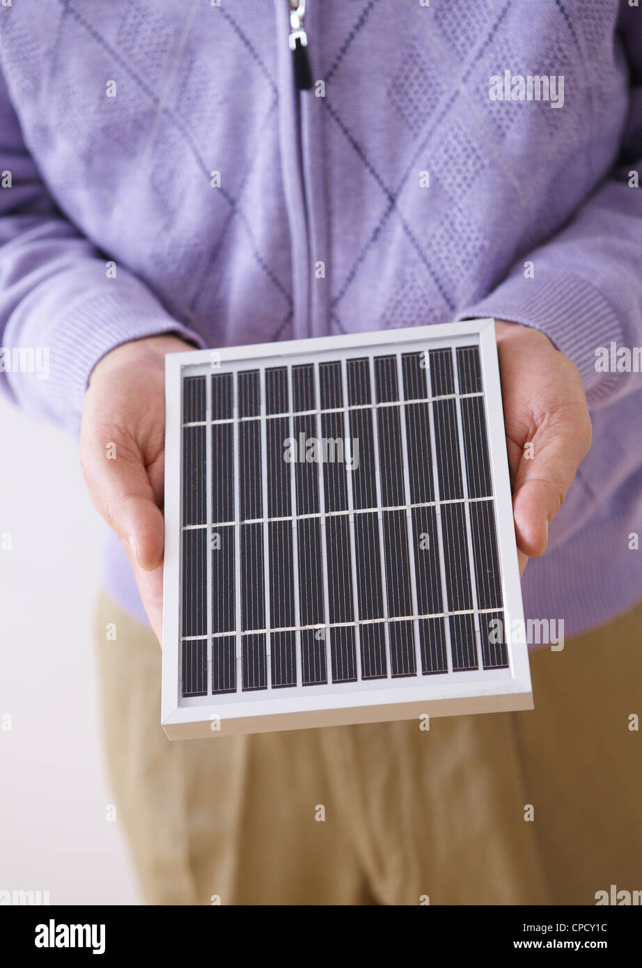 Man holding solar panel Stock Photo - Alamy