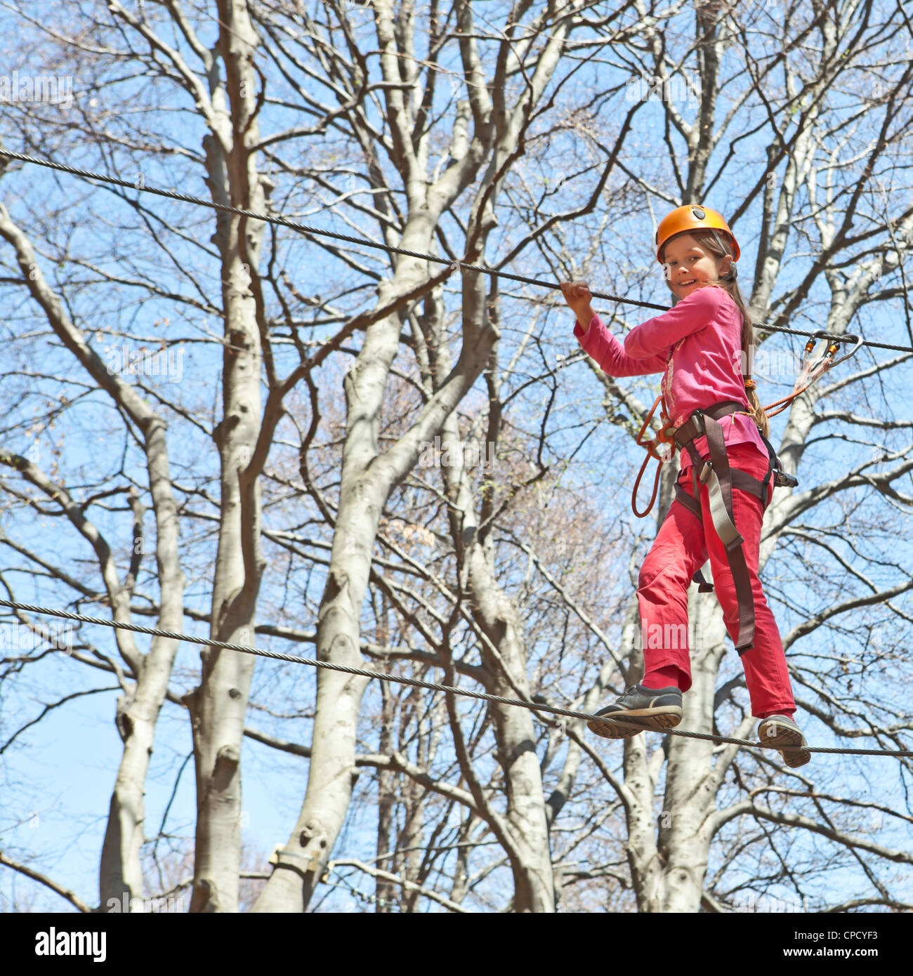 young girl balancing on a rope in a crag Stock Photo - Alamy