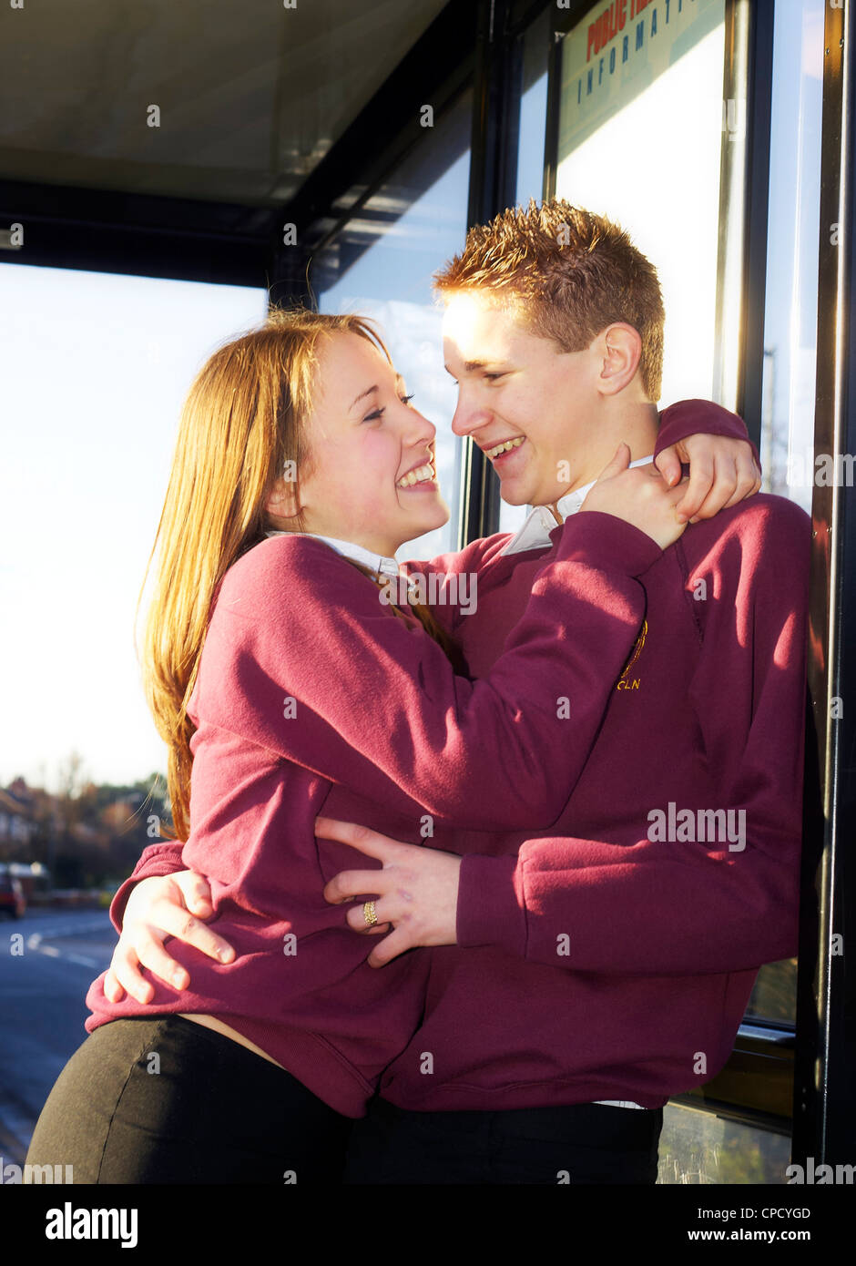 Two teenagers at bus stop Stock Photo - Alamy