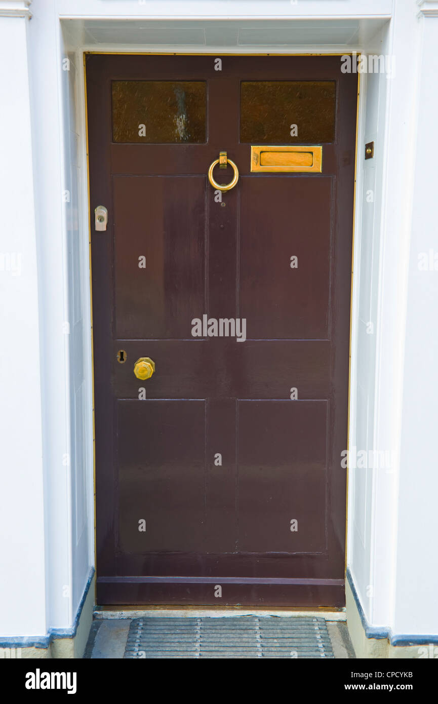 Wooden front door with brass knob knocker and letterbox of period house ...