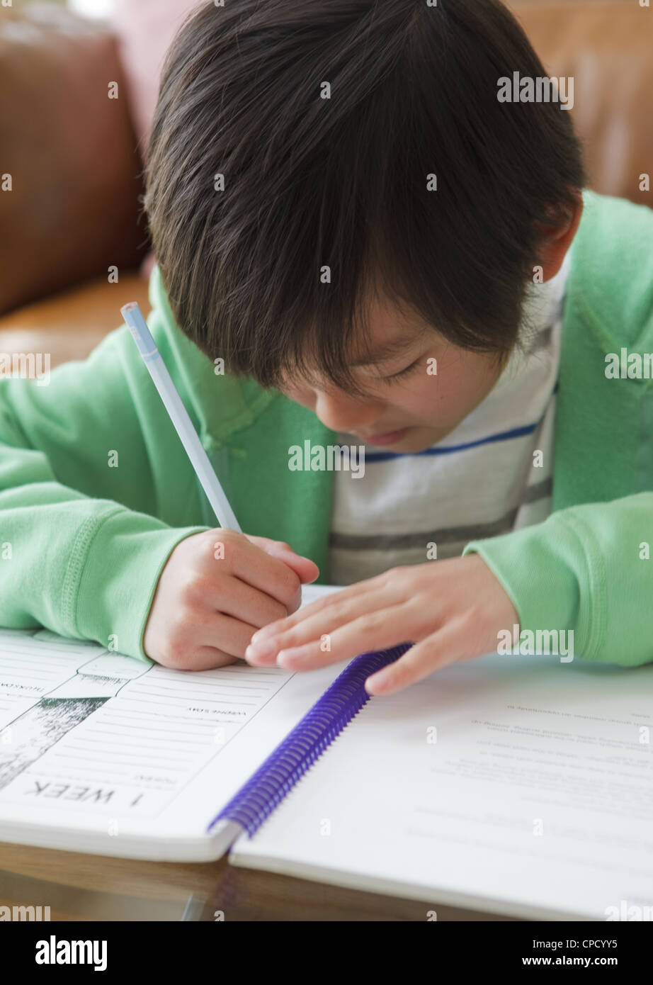 Boy studying in a living room Stock Photo - Alamy