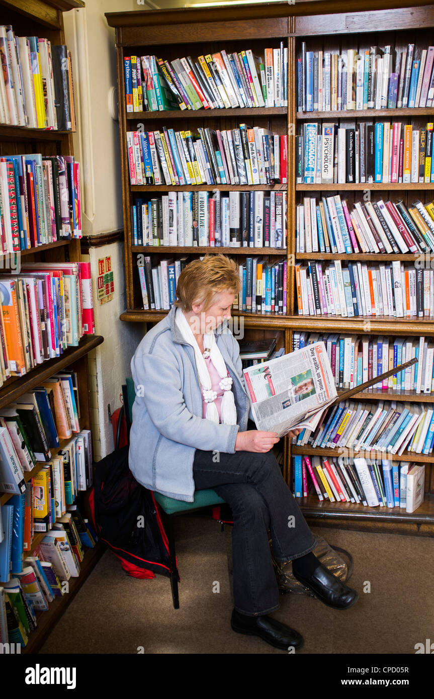 A woman reading welsh language newspapers in the old Aberystwyth ...