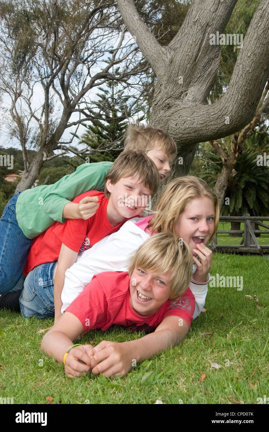 Four children playing in park Stock Photo - Alamy