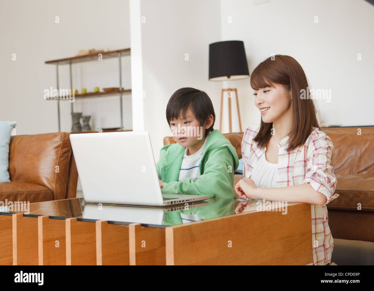 Mother and son looking at laptop Stock Photo - Alamy