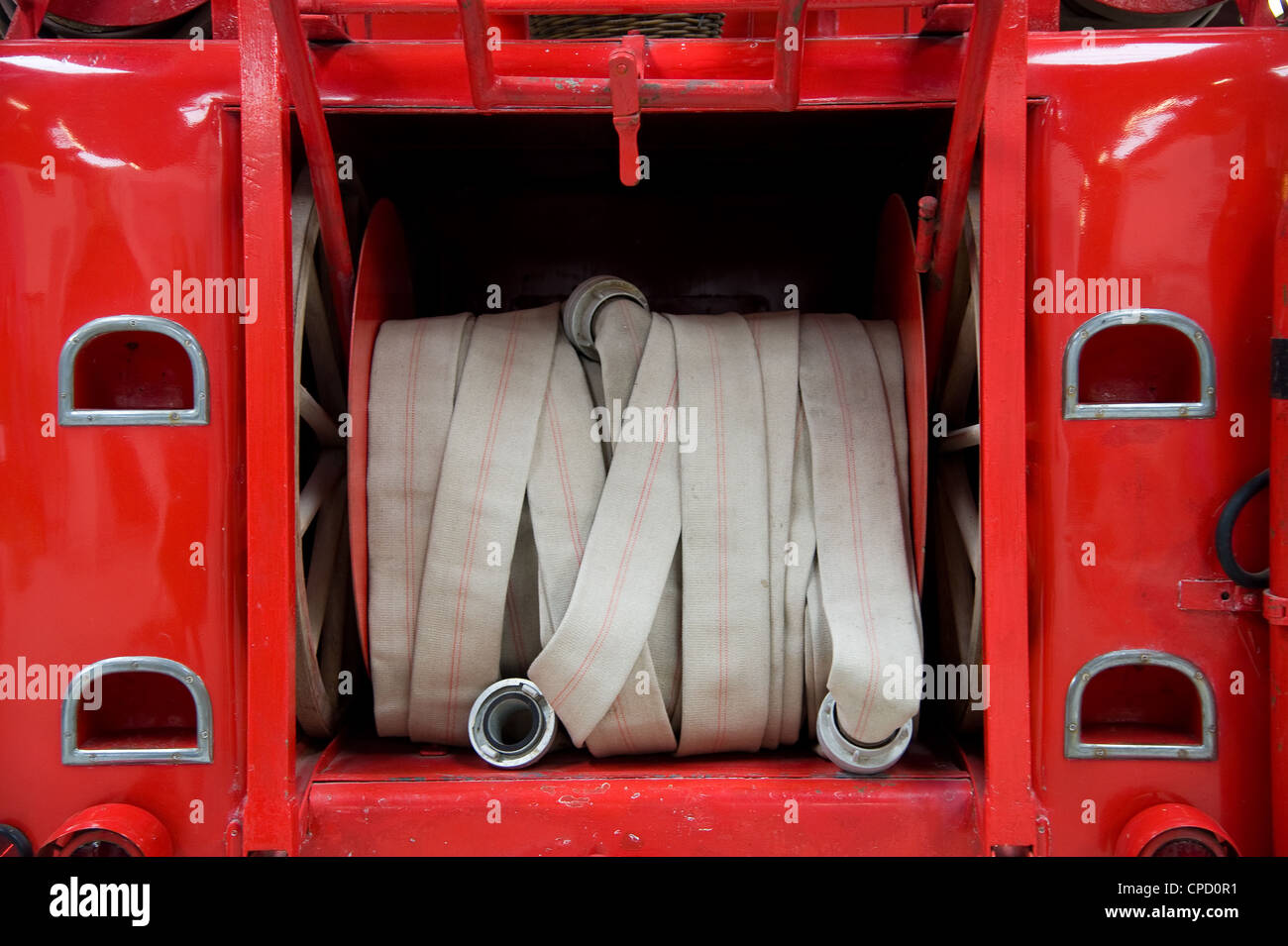 Rolled up firehose at the back of a red firetruck Stock Photo - Alamy