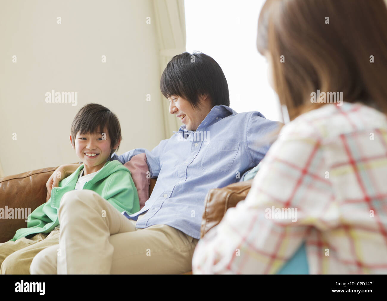 Family relaxing in a living room Stock Photo - Alamy