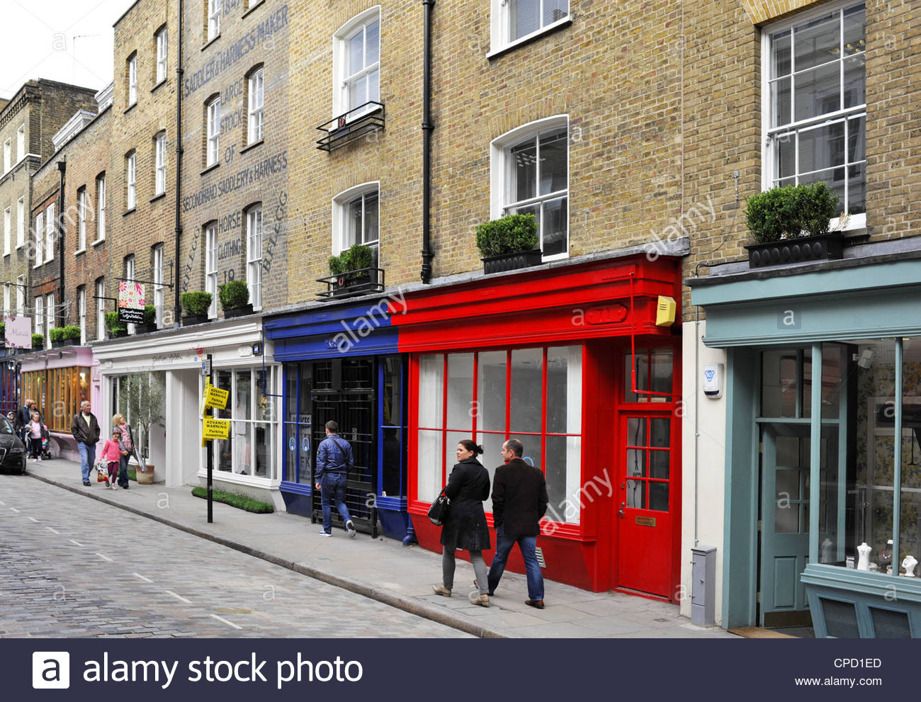 Colorful storefronts street with traditional brick houses, Soho Stock ...
