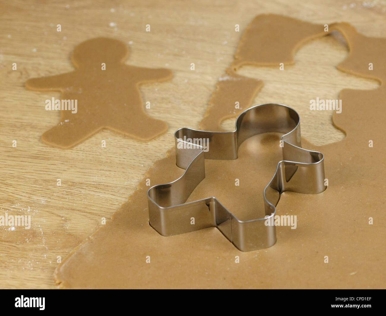 Cutting out gingerbread men Stock Photo - Alamy