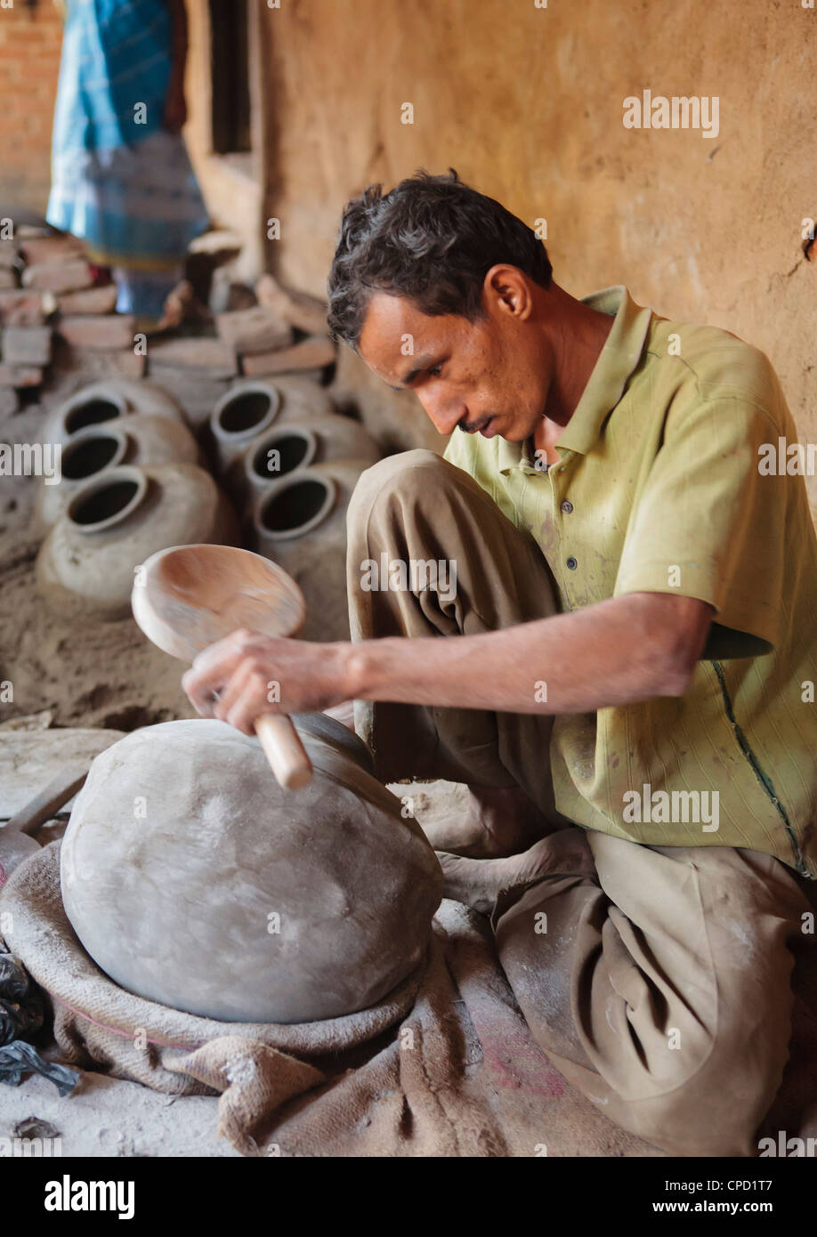 Local potter making earthenware pots for food storage and cooking ...
