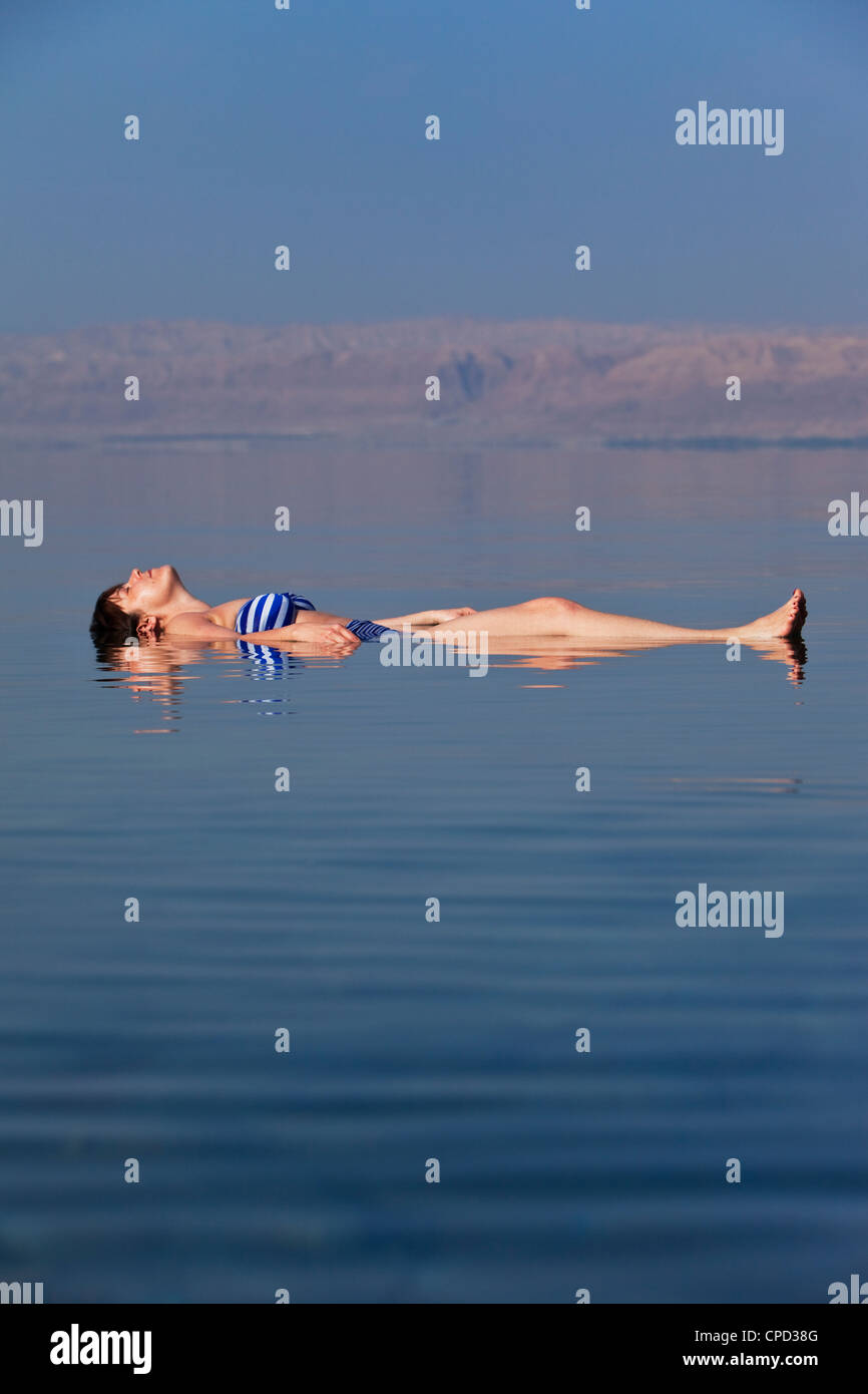 Young woman floating in the Dead Sea, Movenpick Resort Hotel, Jordan ...