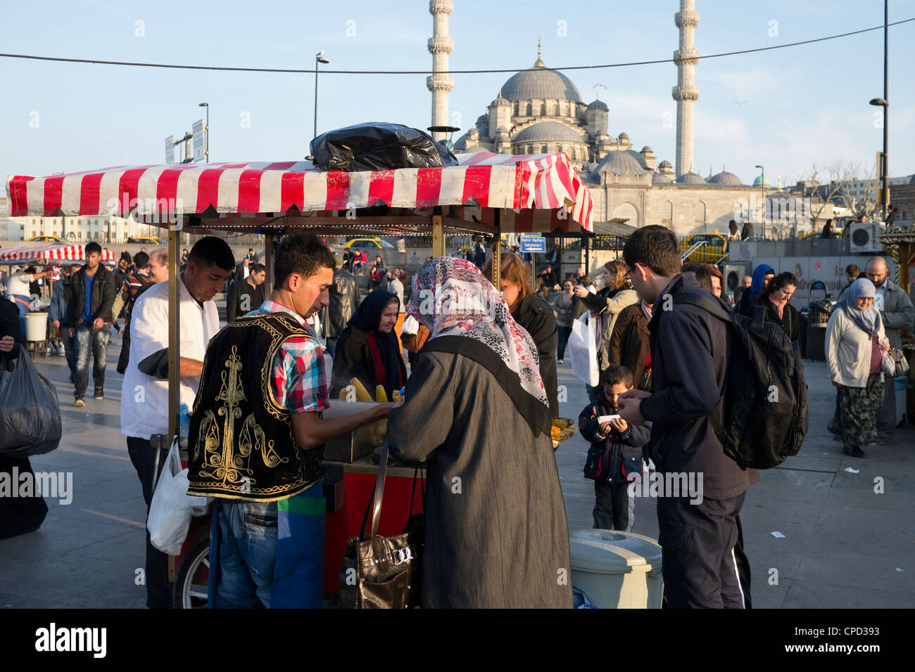 Turkish woman with veil buying from corn vendor at New Mosque, Istanbul ...