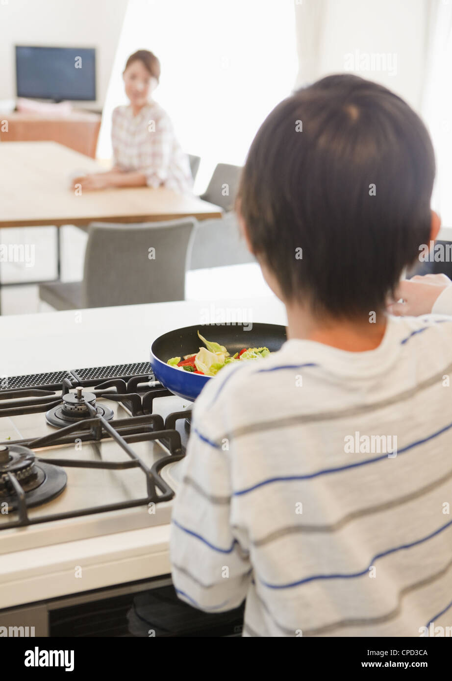 Cooking boy's back Stock Photo - Alamy