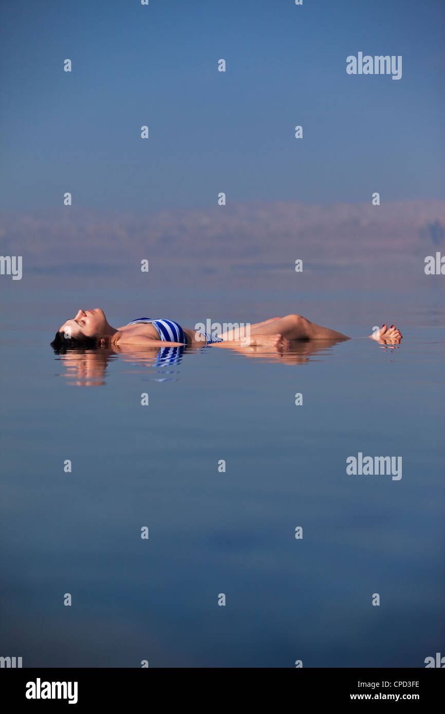 Young woman floating in the Dead Sea, Movenpick Resort Hotel, Jordan ...