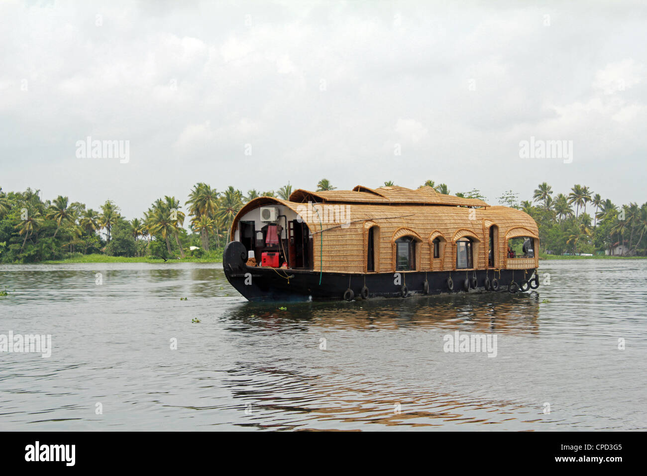 Houseboat cruising through the backwaters of Kerala, India Stock Photo ...