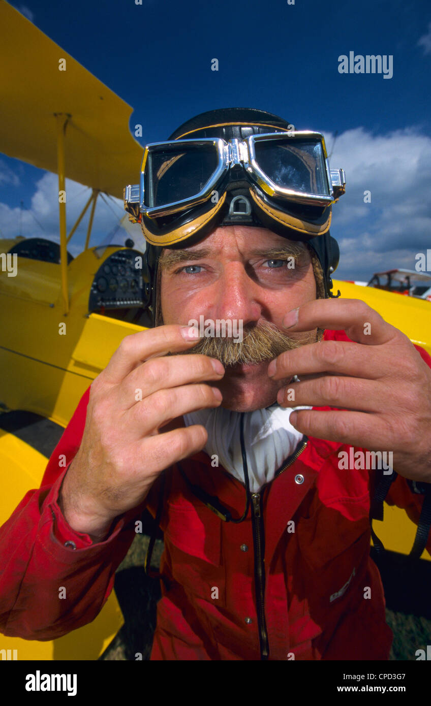 Pilot of ultra light biplane Kiebitz arranging his mustache after a ...
