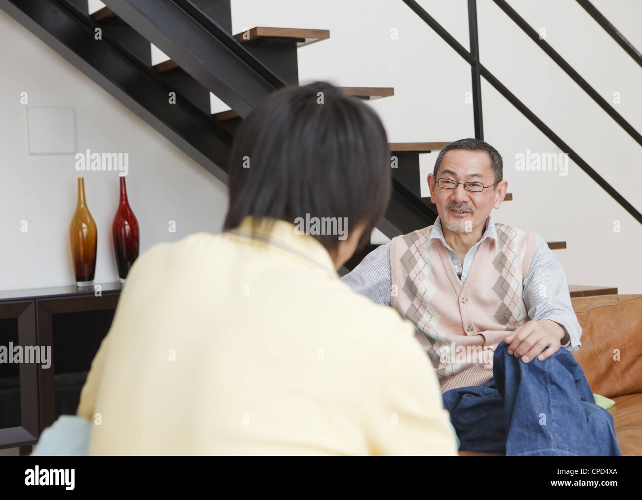 Two men chatting in a living room Stock Photo - Alamy