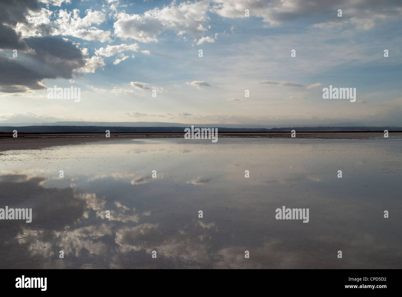 Reflection of the sky with clouds in salt flats of Atacama Stock Photo ...