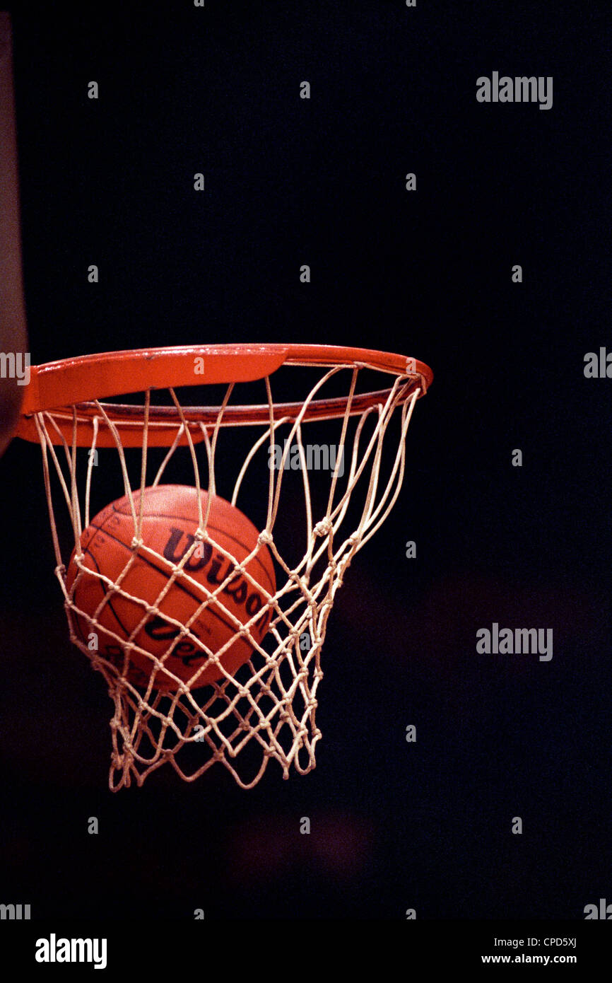Basketball going through the hoop Stock Photo - Alamy