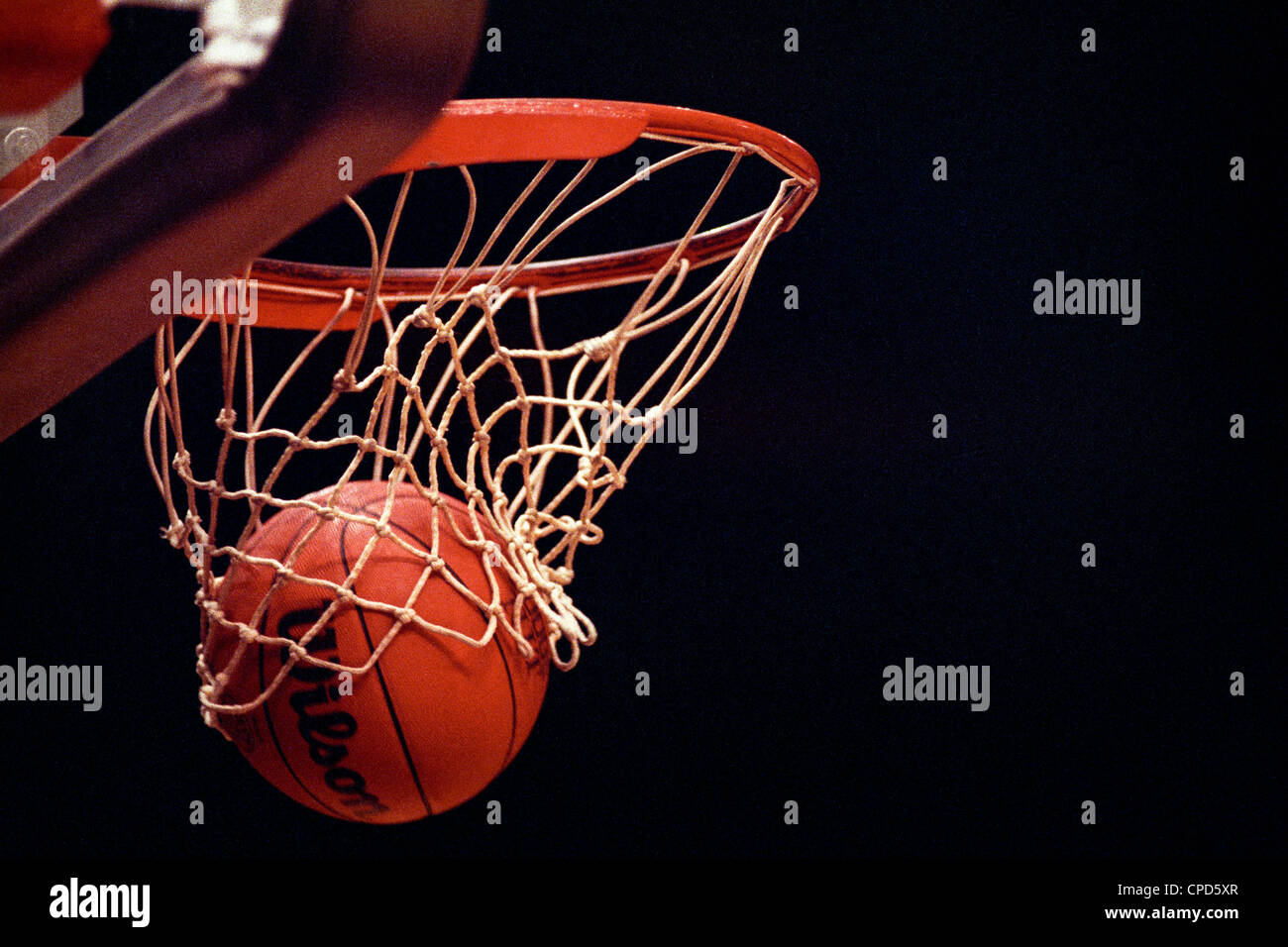 Basketball going through the hoop Stock Photo - Alamy