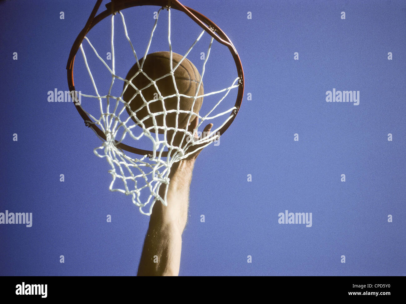 Basketball going through the hoop Stock Photo - Alamy