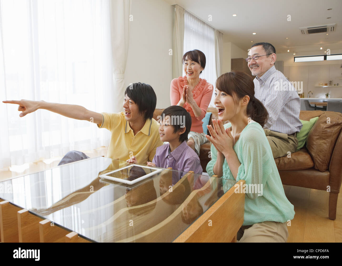 Three-generation family watching TV Stock Photo - Alamy