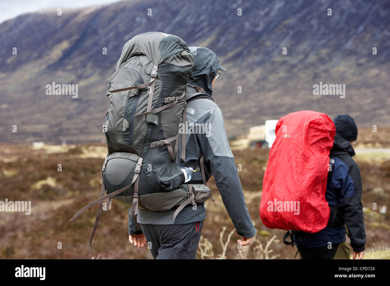 two male walkers hikers carrying full backpacks prepared for the wilds ...