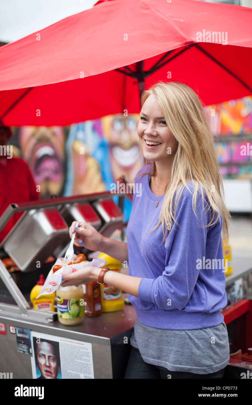 Woman with street food East London Stock Photo - Alamy