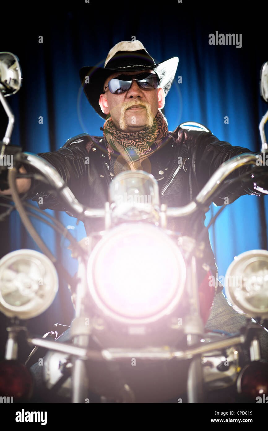 Hispanic biker sitting on motorcycle Stock Photo - Alamy
