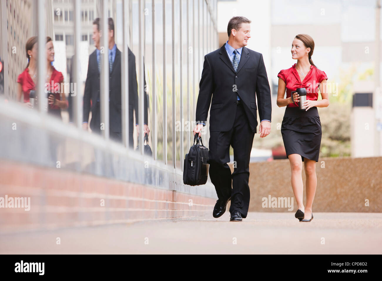 Caucasian co-workers walking together outdoors Stock Photo - Alamy