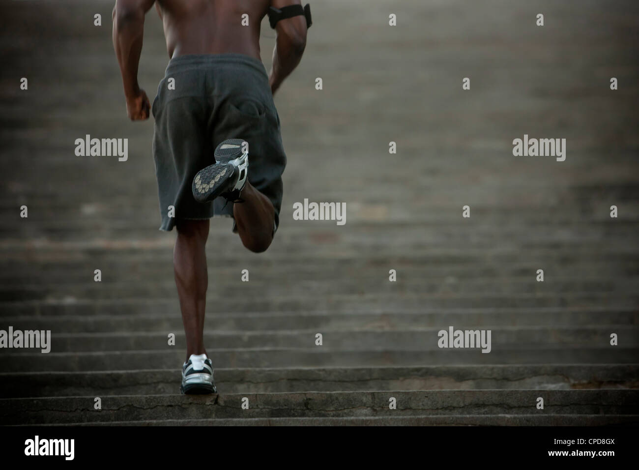 Black man running up stairs Stock Photo - Alamy