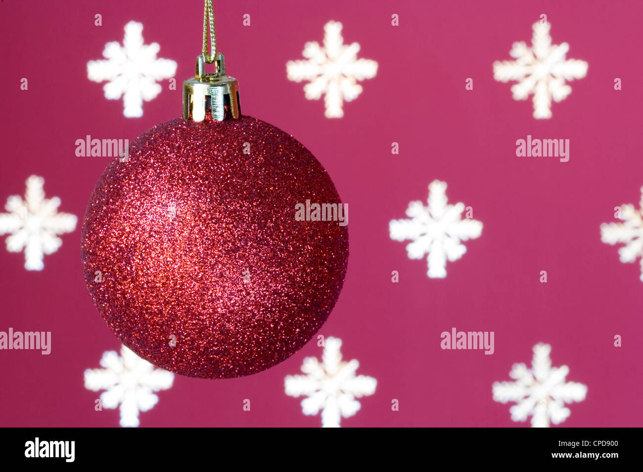 Christmas ball pending with a snow effect background (selective and ...