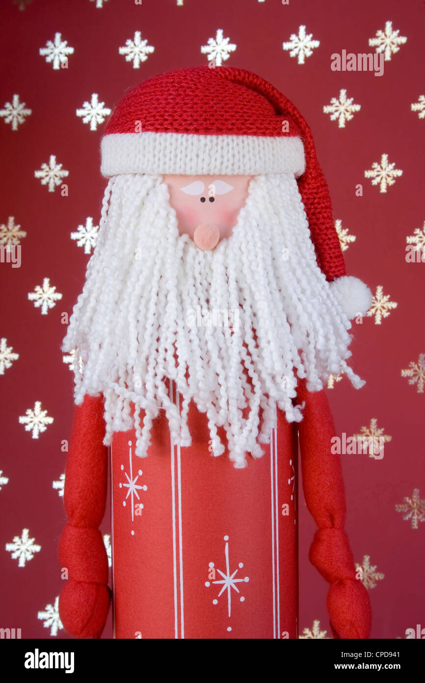 a Santa Clause Decoration over a Christmas wallpaper Stock Photo - Alamy