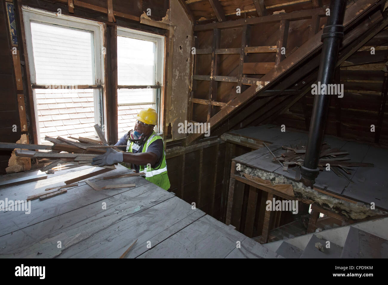 Workers salvage building materials from a home being "deconstructed ...