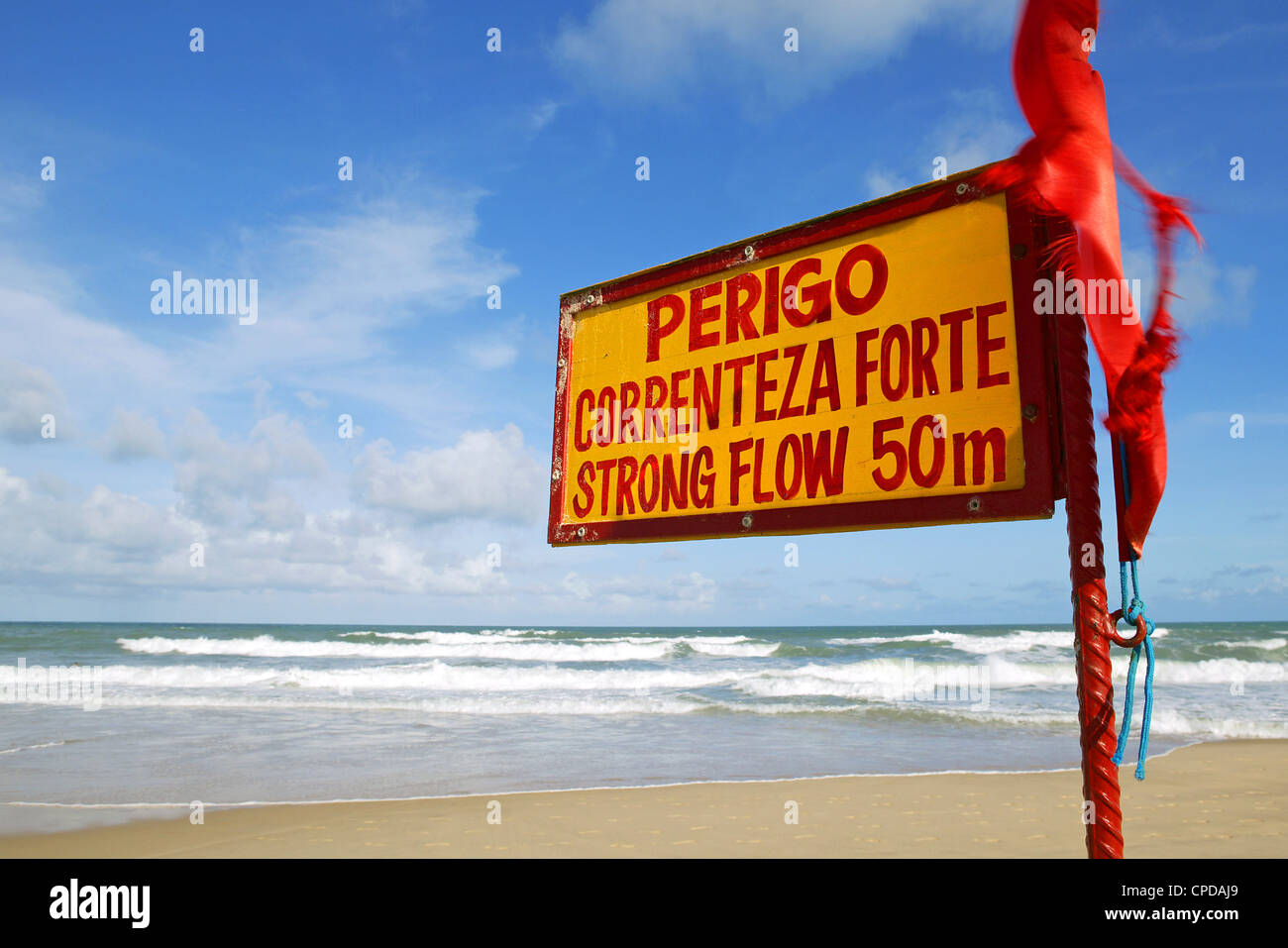 Brazil empty beach warning sign for strong current and rip tide sand ...
