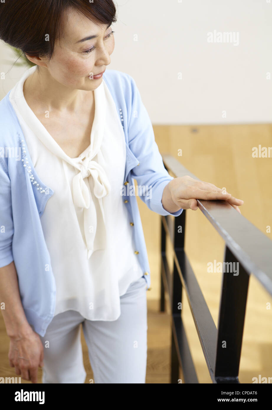 Senior woman going up stairs hi-res stock photography and images - Alamy