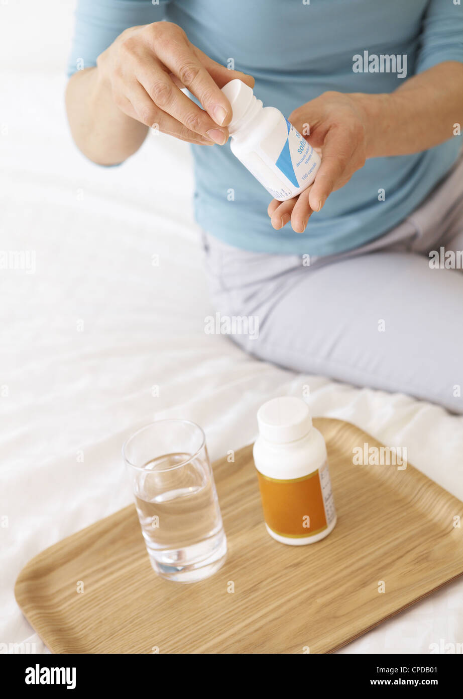 Woman taking supplements Stock Photo - Alamy