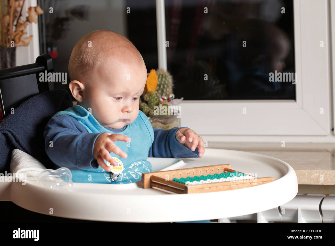 portrait of 6 months male child baby boy in blue eye, playing with ...