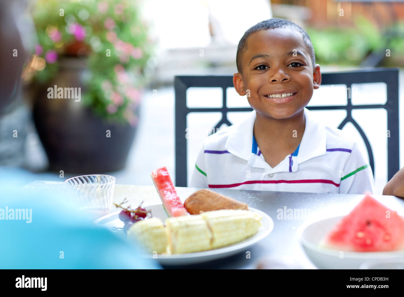 African boy eating corn hi-res stock photography and images - Alamy