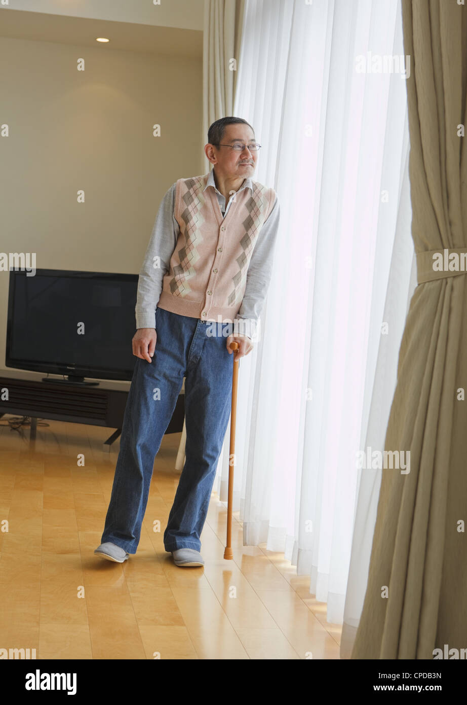 Senior man using a stick Stock Photo - Alamy